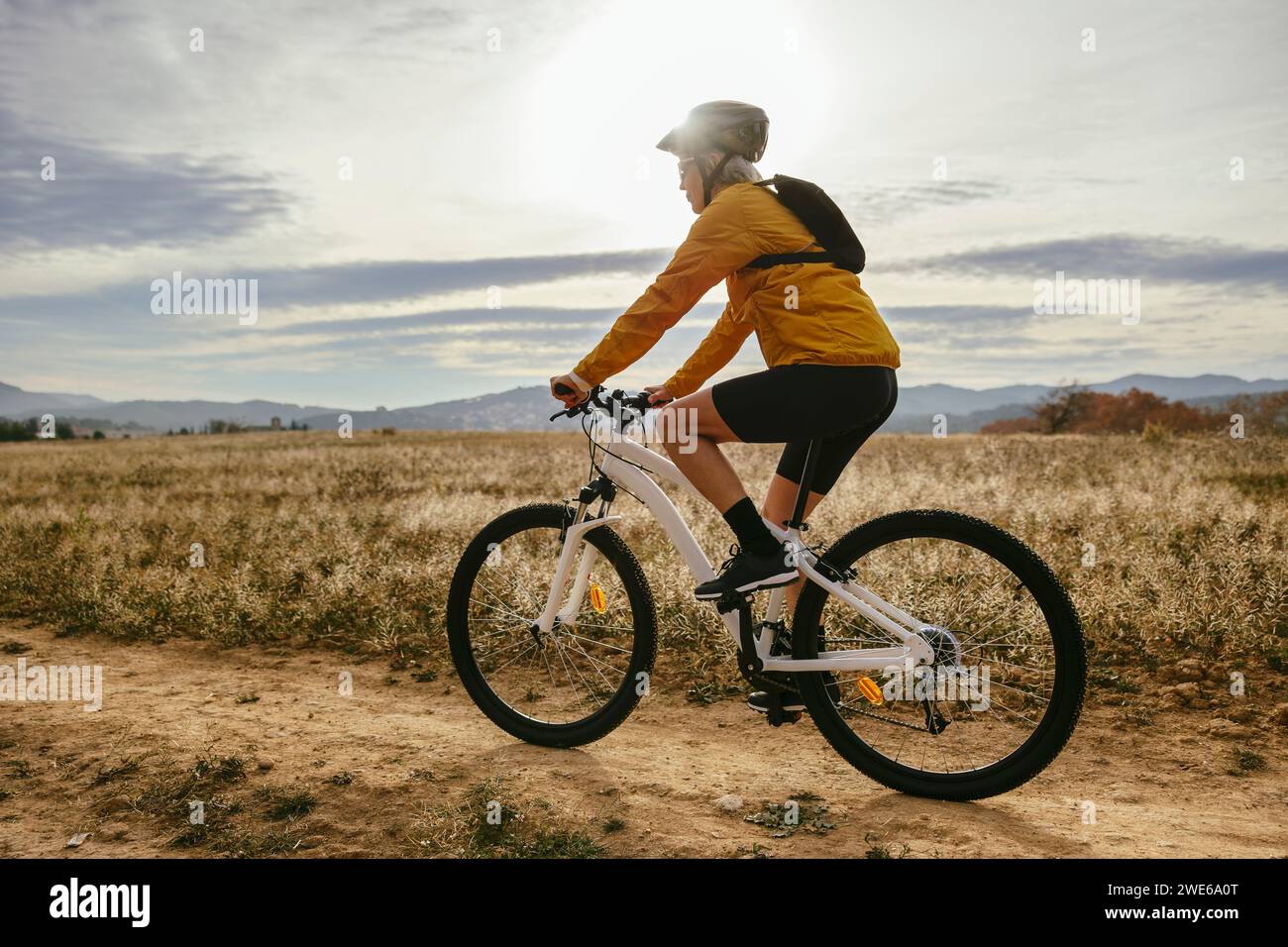 Woman riding bike sunset hi-res stock photography and images - Alamy