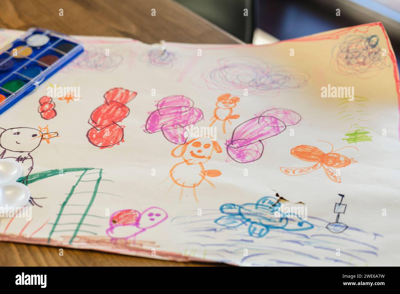 Paper with children drawing on table at home Stock Photo - Alamy