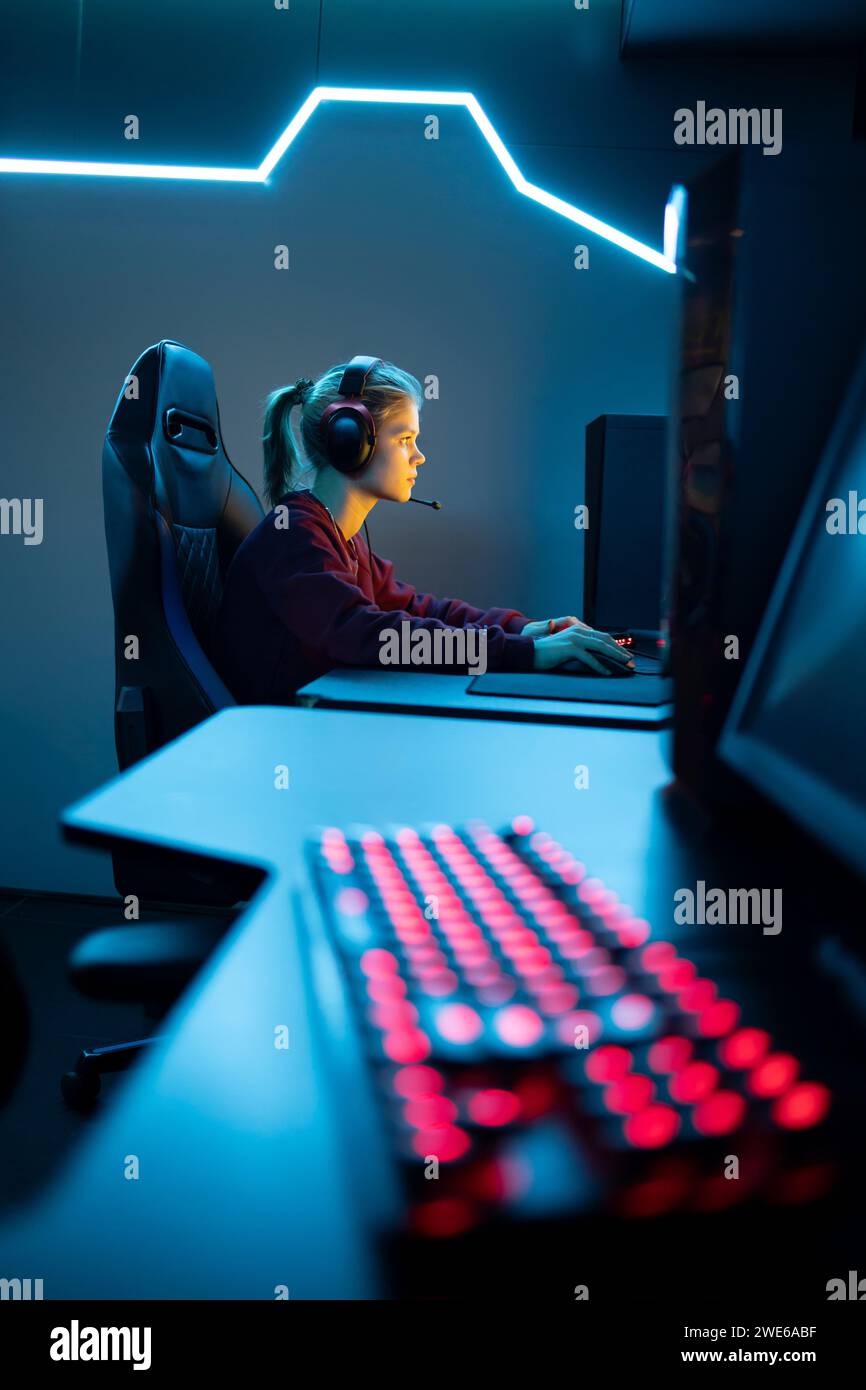 Gamer sitting on chair and playing video game Stock Photo - Alamy
