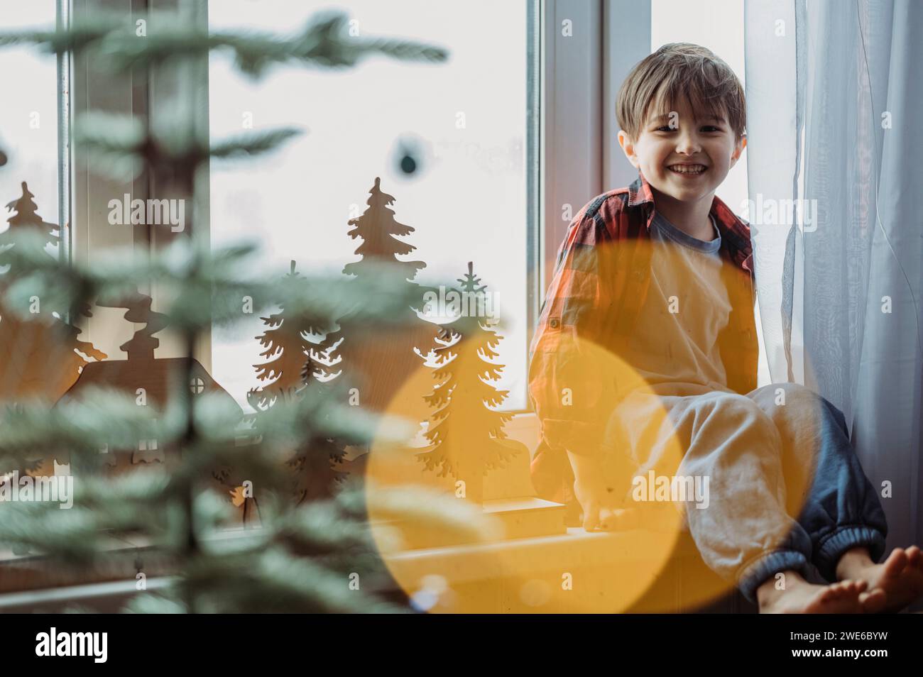 Boy sitting window sill hi-res stock photography and images - Alamy