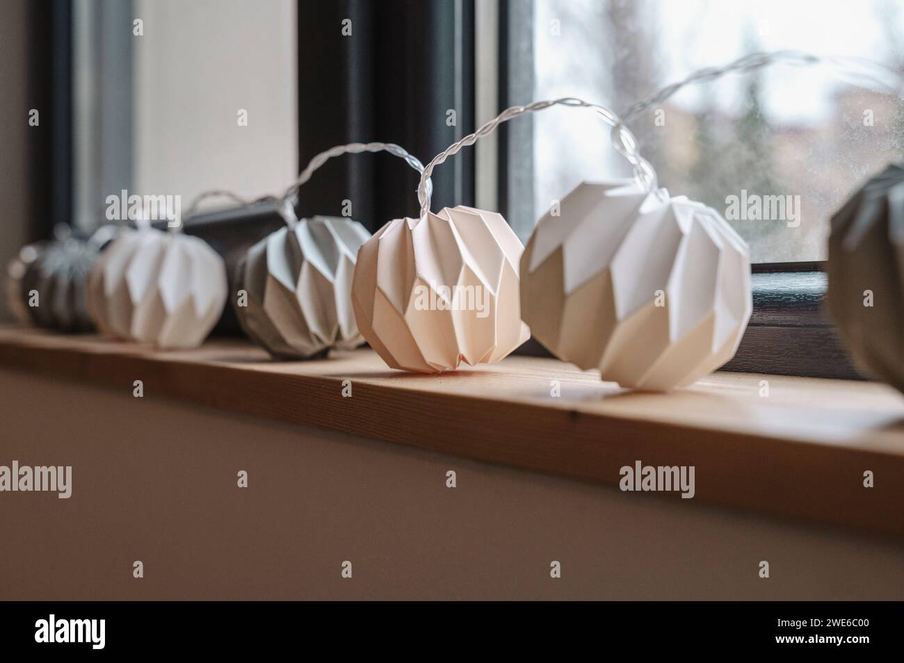 White paper garland decorated on window sill Stock Photo - Alamy