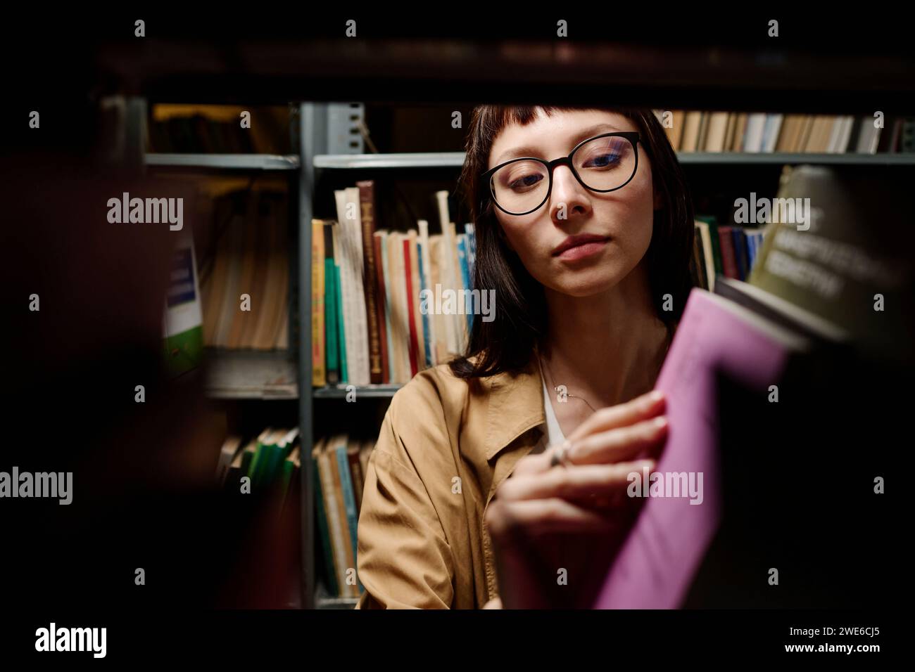 Woman reaching shelf hi-res stock photography and images - Alamy