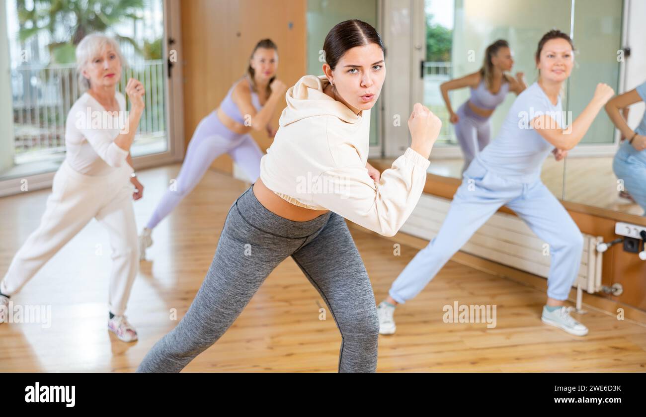 Group are practising arch movement in step jazz dance in fitness gym ...