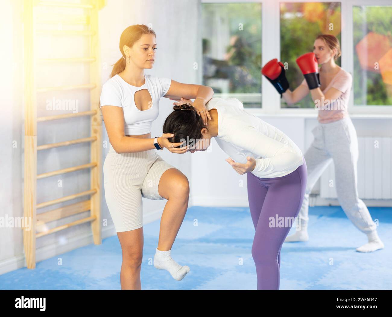 Self defense class - woman practices blows to the head of an attacking ...
