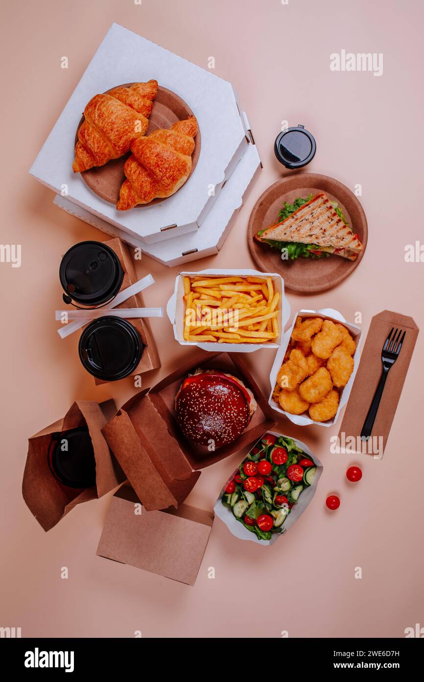 Varieties of fast foods with salad against beige background Stock Photo ...