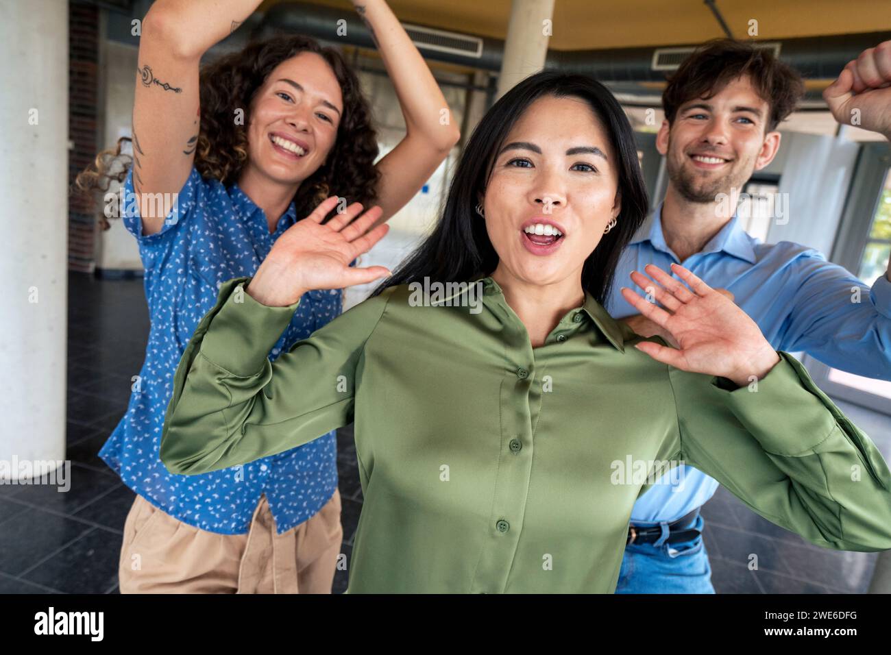 Happy multiracial business colleagues dancing in lobby Stock Photo - Alamy