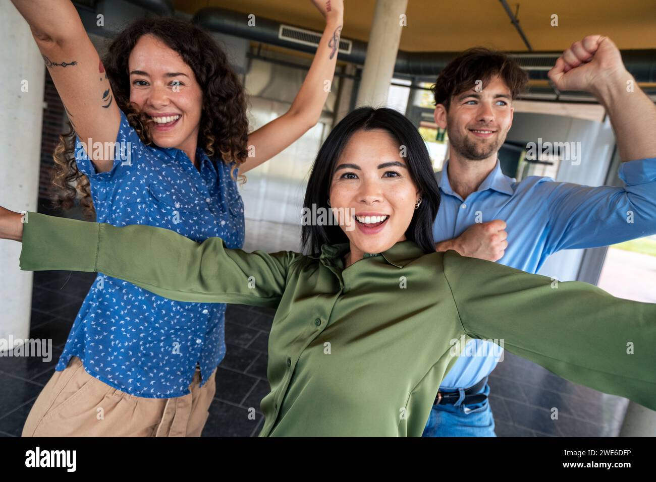 Cheerful multiracial business colleagues dancing in office lobby Stock ...