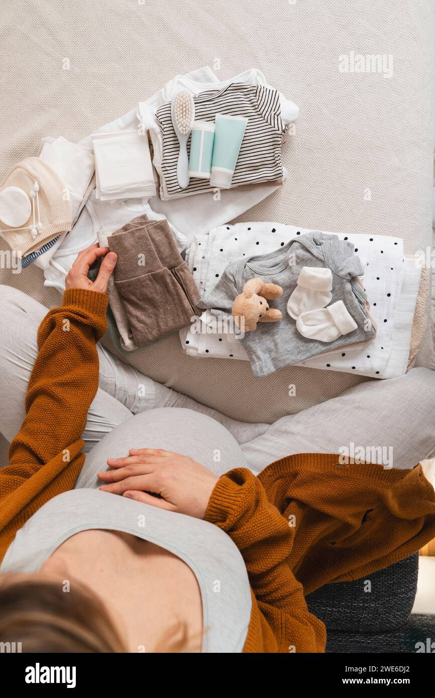 Pregnant woman packing baby hi-res stock photography and images - Alamy