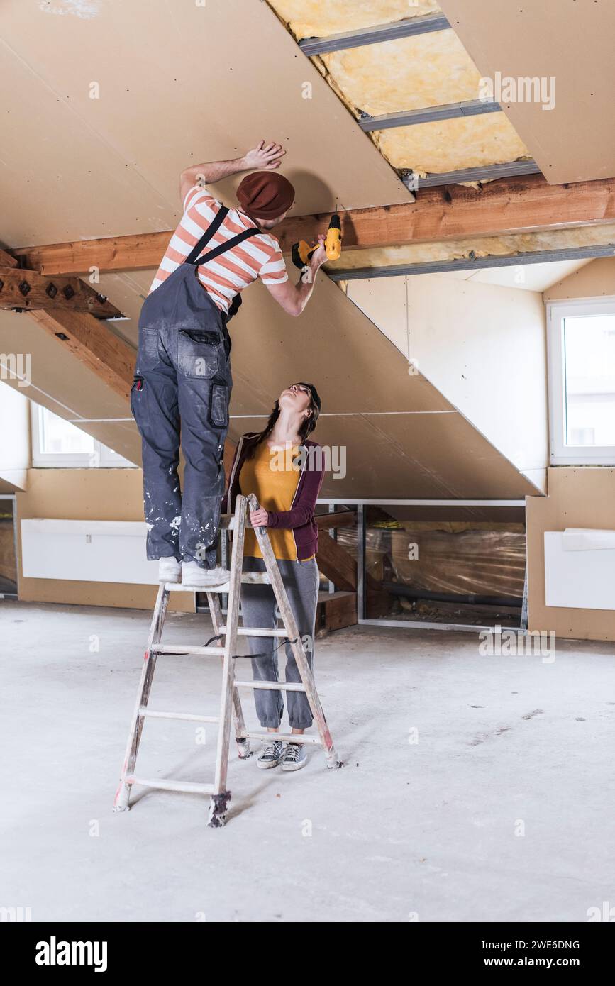 Man standing on ladder hi-res stock photography and images - Alamy