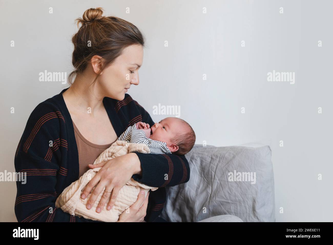 Mother carrying son sitting hi-res stock photography and images - Alamy