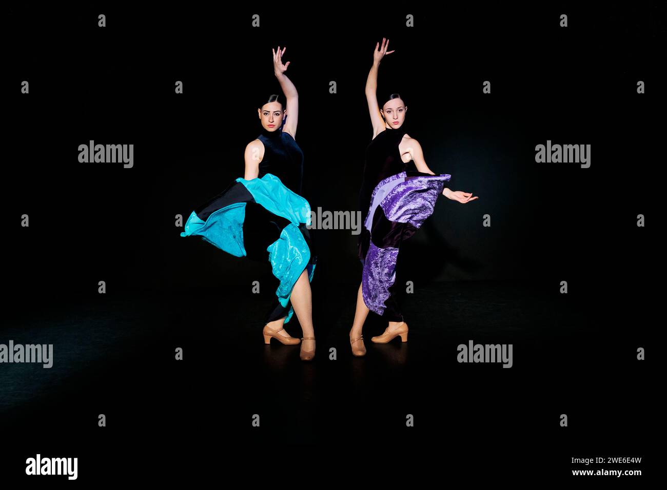 Beautiful flamenco dancers performing against black background Stock ...