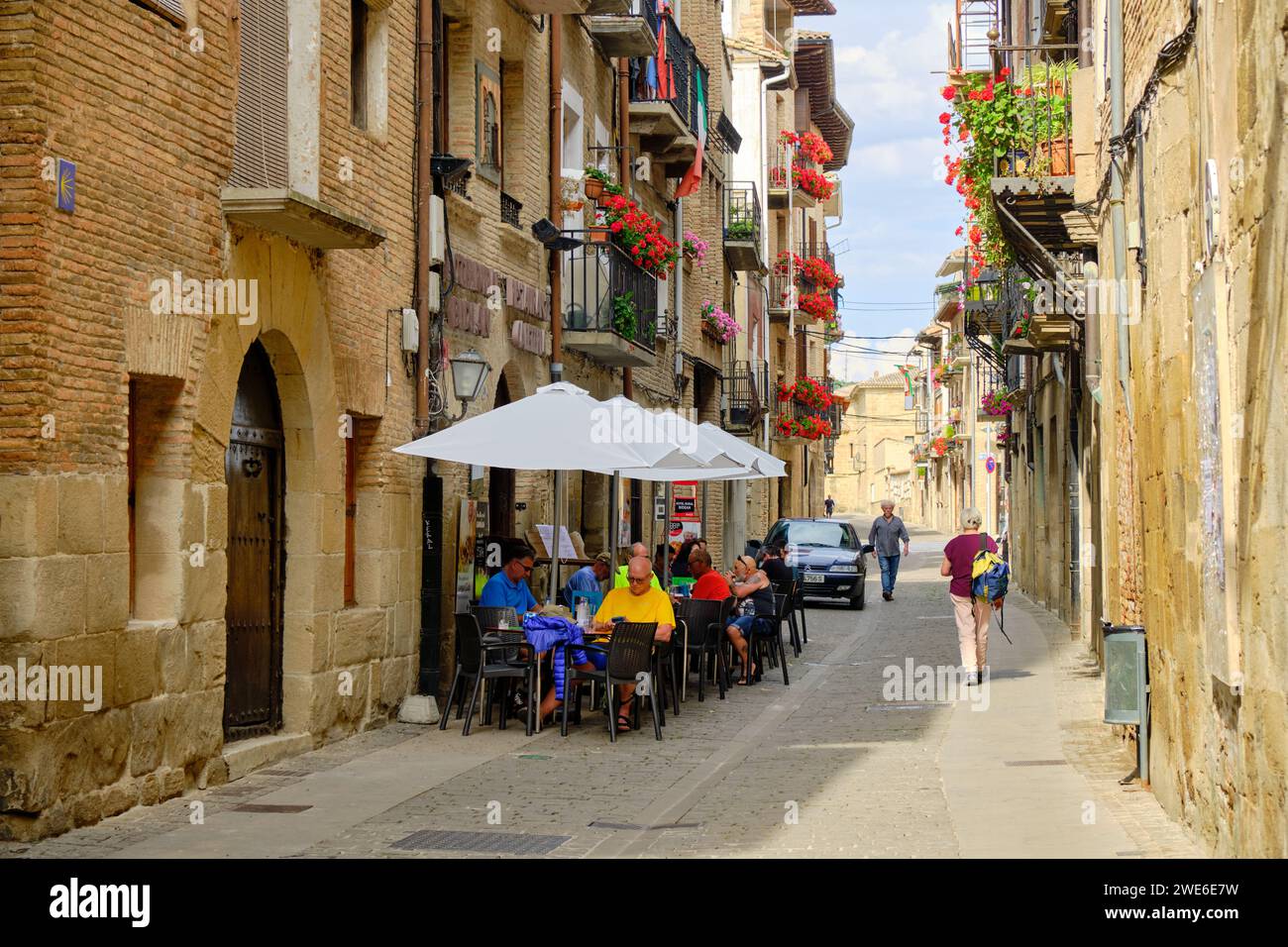 People sitting in outdoor terrasse of a restaurant in old city streets ...