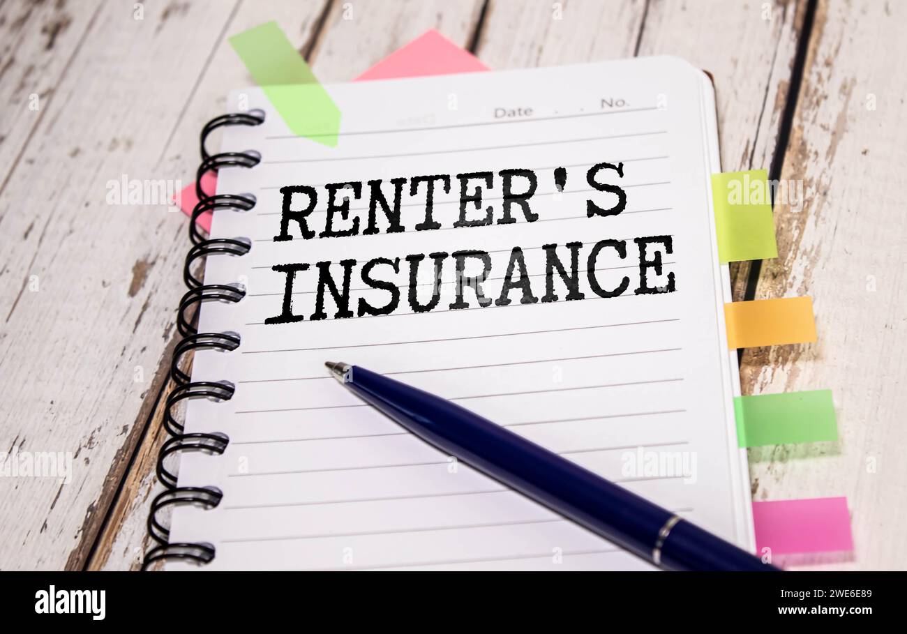 RENTER'S INSURANCE text on paper clipboard with magnifier and keyboard ...