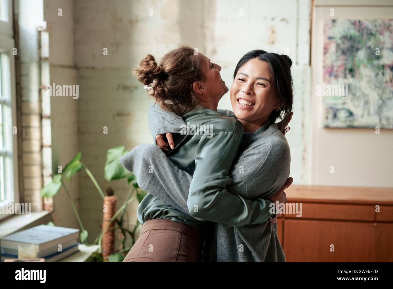 Happy women hugging each other hi-res stock photography and images - Alamy