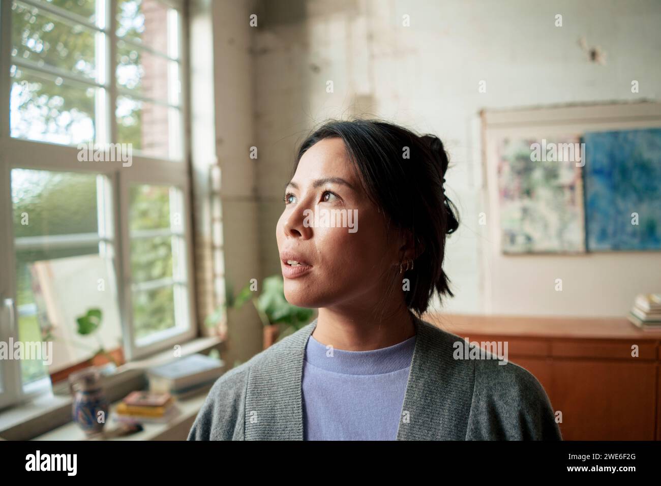 Thoughtful artist looking away in art studio Stock Photo - Alamy