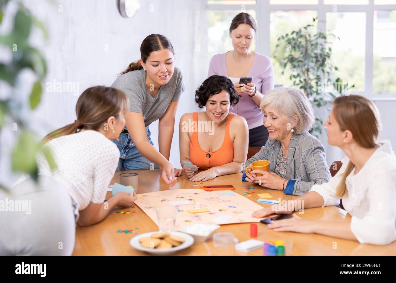 Group of of different years people playing tabletop game Stock Photo ...