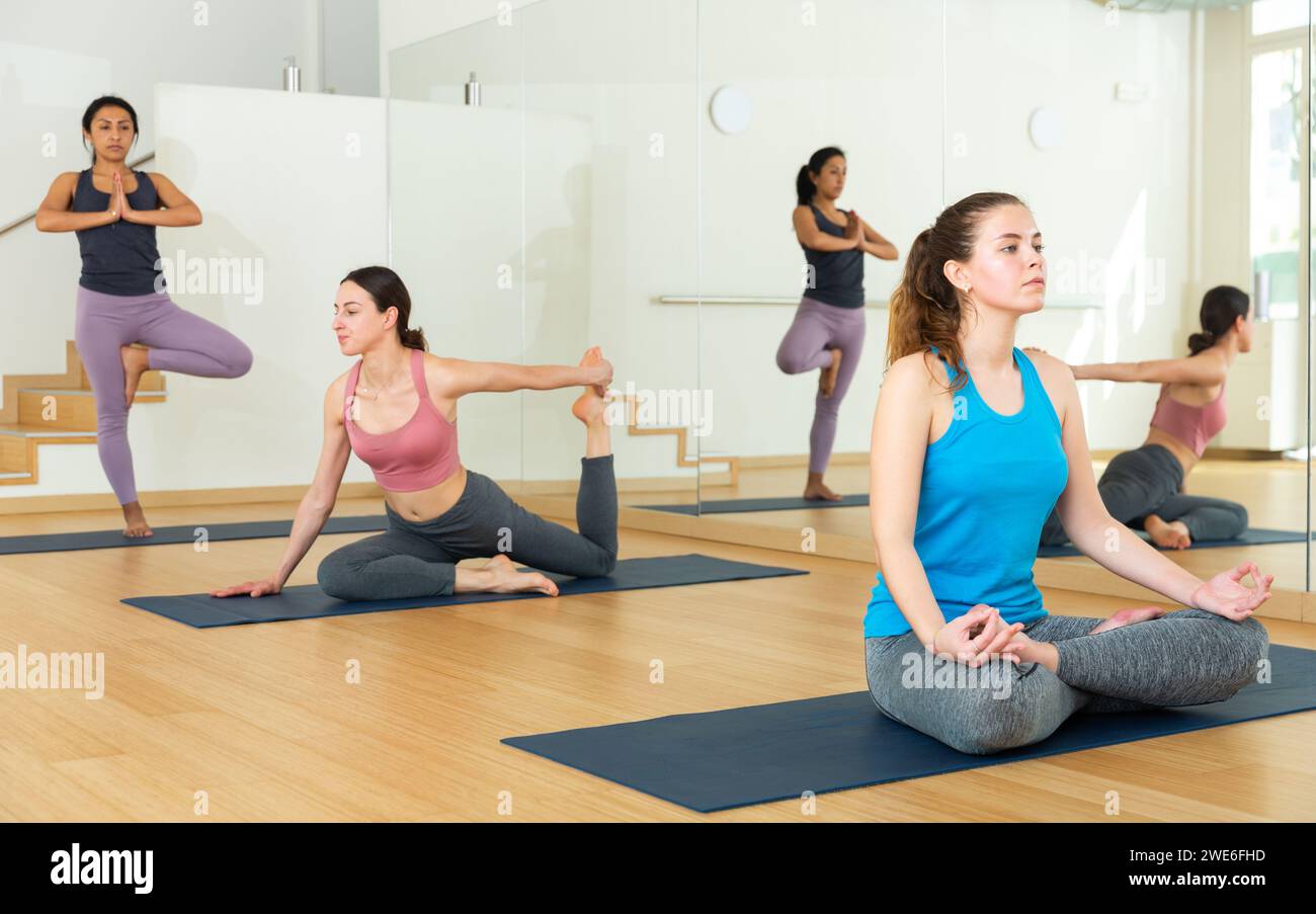 Young women exercising Hatha yoga poses in studio Stock Photo - Alamy