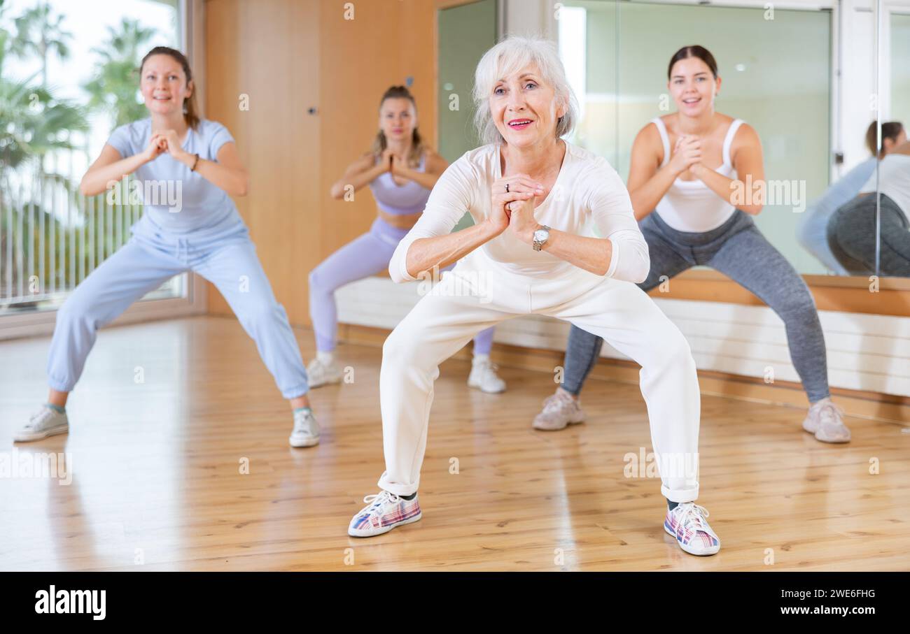 Cheerful senior female choreographer showing new dancing dynamic ...