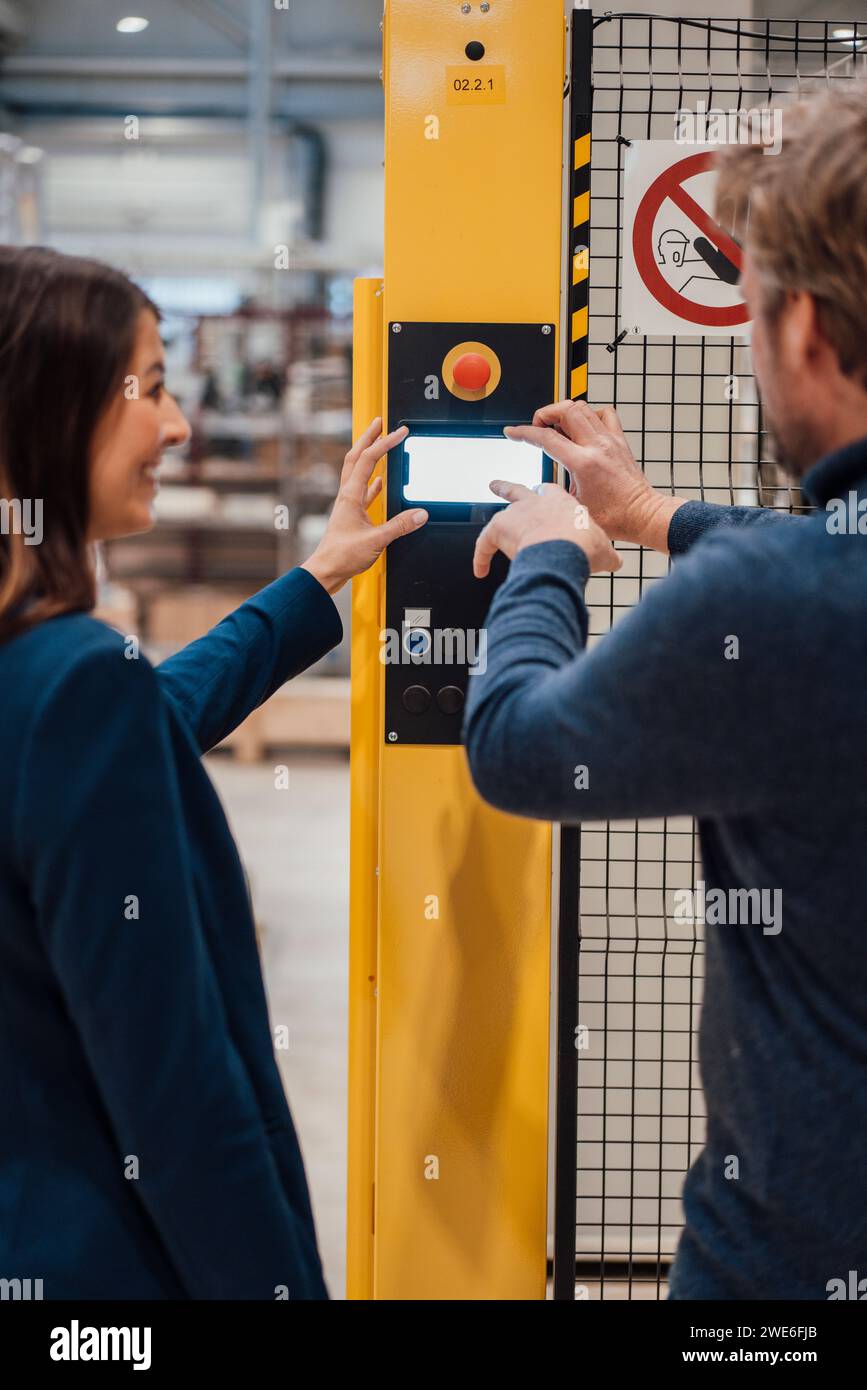 Engineers using control panel standing in industry Stock Photo - Alamy