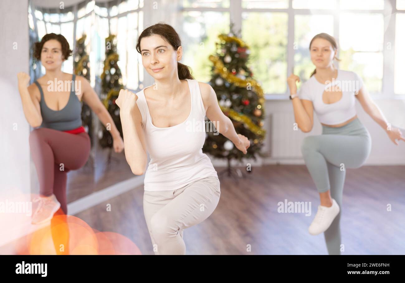 Girl conducts modern dance lessons for group of women during New Year ...