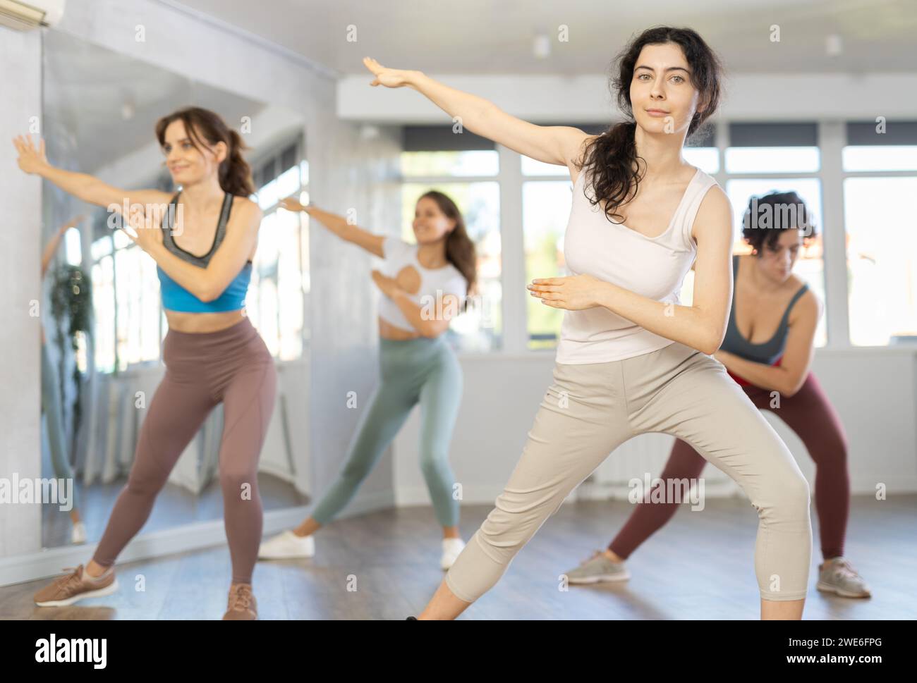 Young female teacher conducts modern hip hop dance lessons for group of ...