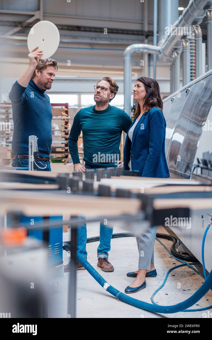 Business colleagues planning strategy together in industry Stock Photo ...