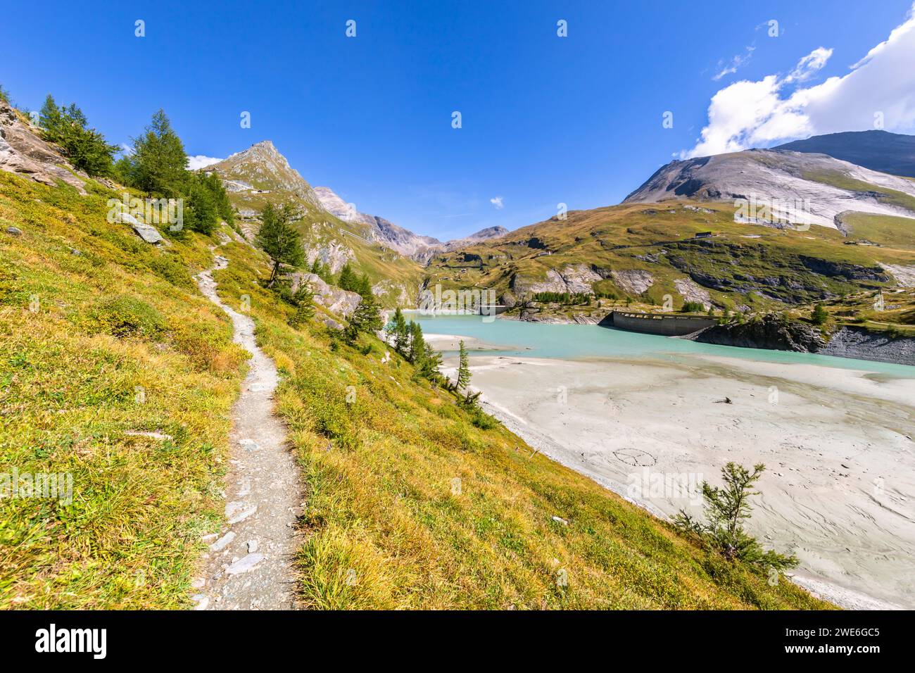Hiking trail near Margaritze reservoir under sky at Hohe Tauern ...