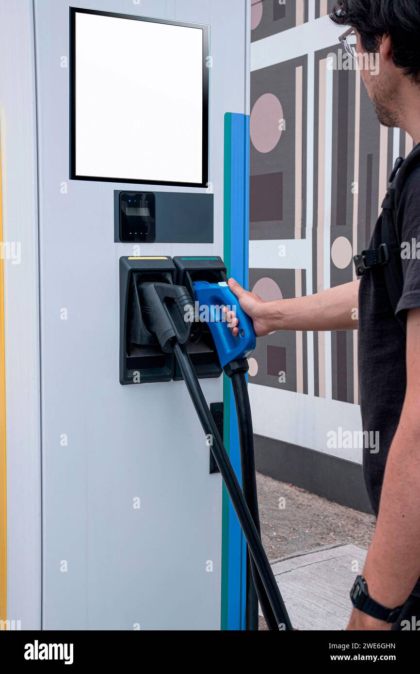 Man holding fuel pump at gas station Stock Photo - Alamy