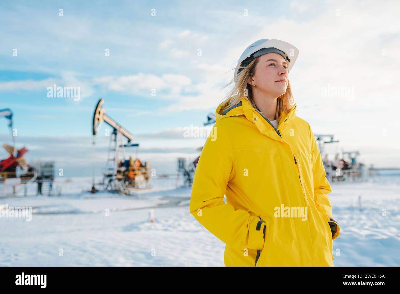 Engineer standing at oil production field in winter Stock Photo - Alamy