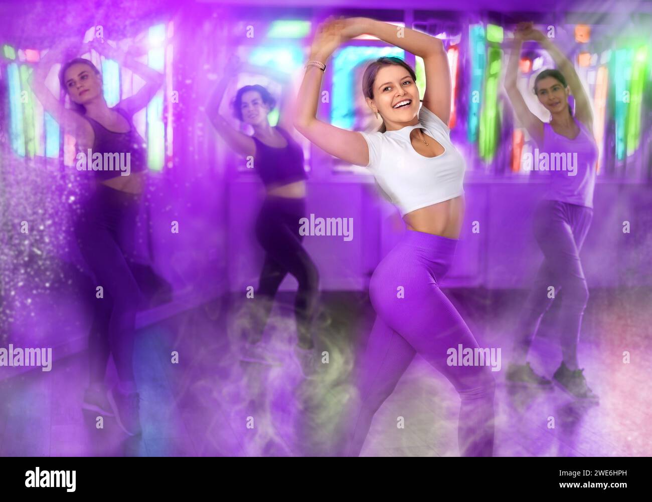 Toned image with visual effects of smiling girl performing energetic ...