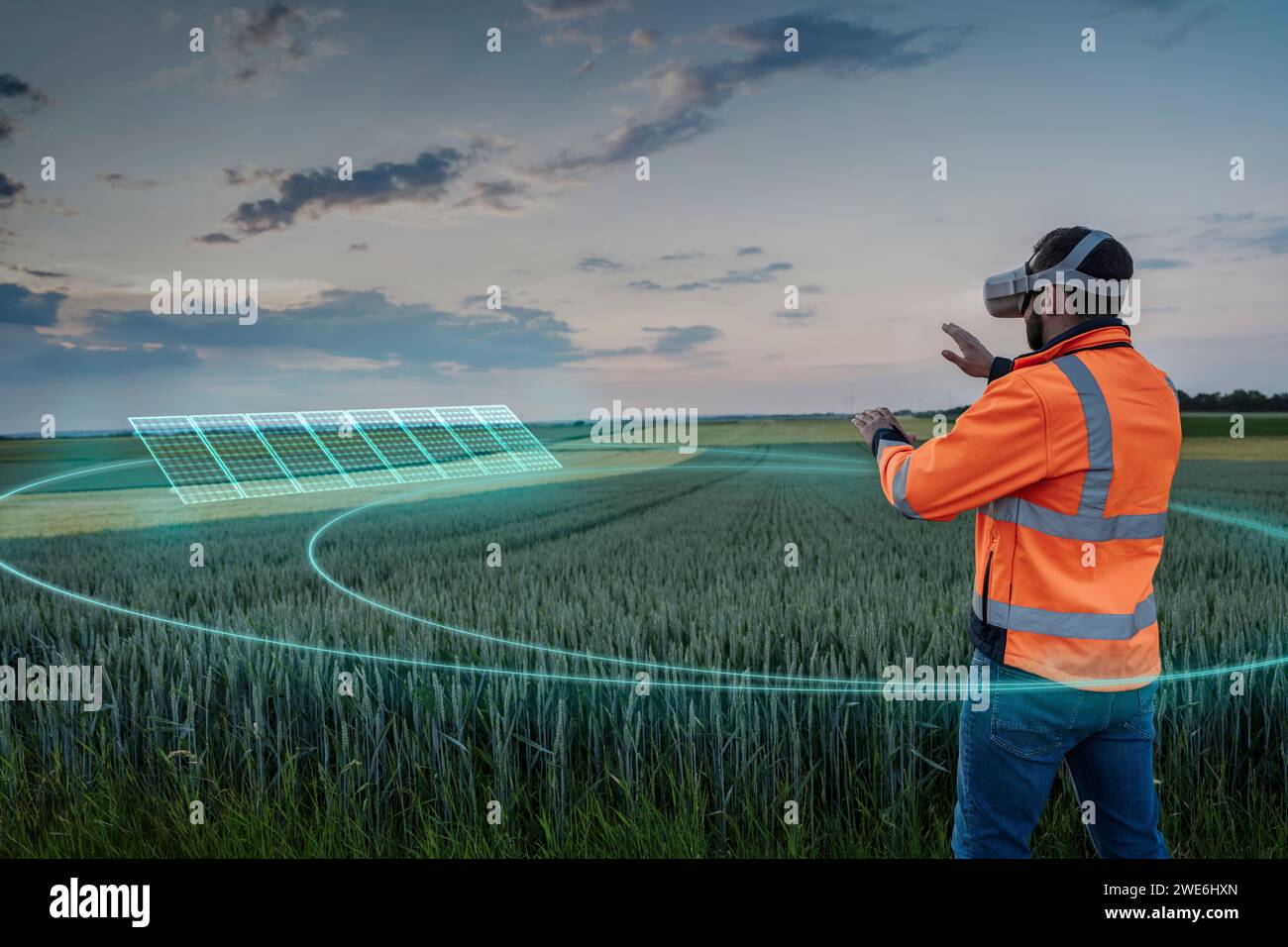 Engineer wearing VR glasses and operating digital solar panels in field ...