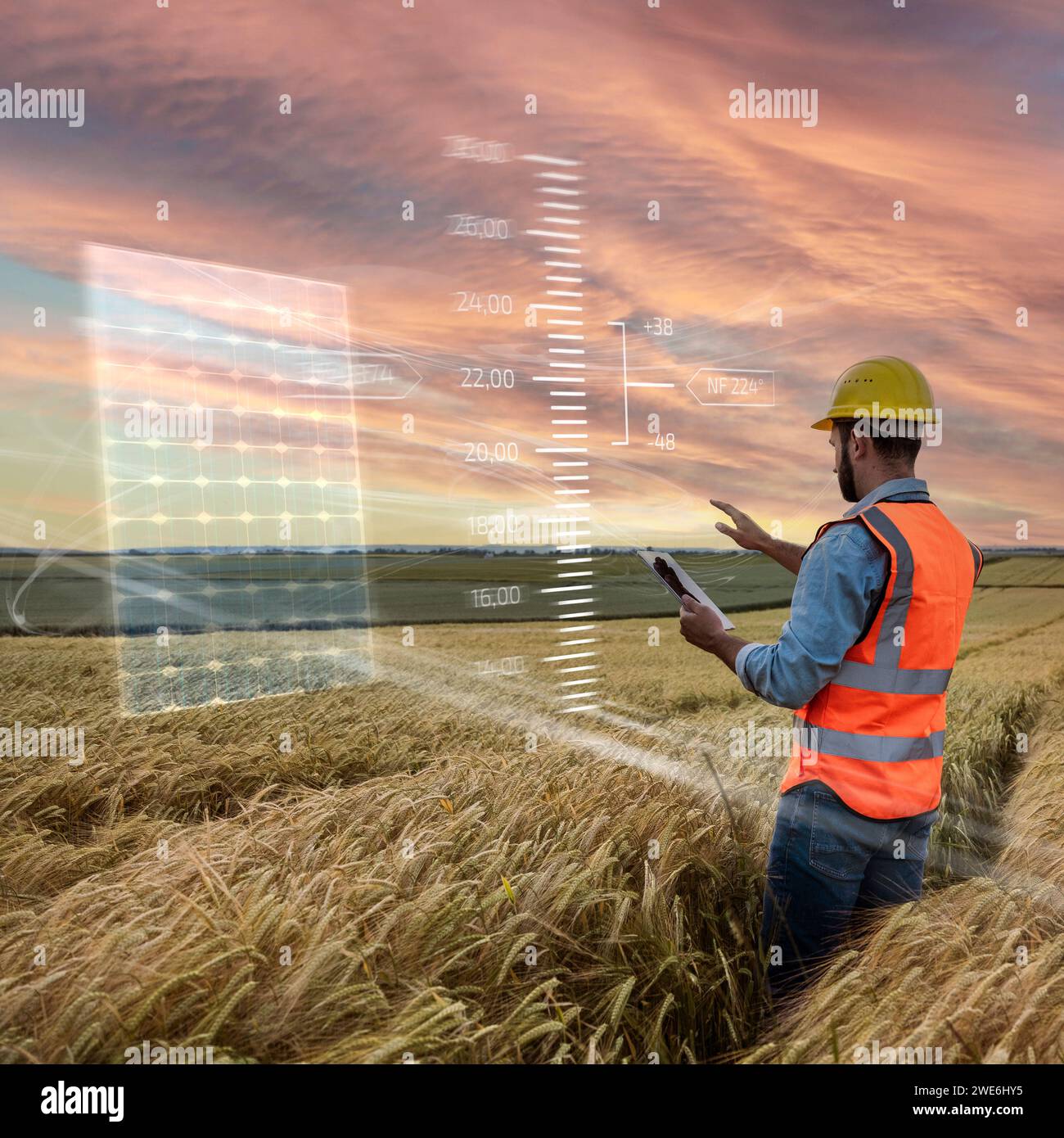 Engineer programming digital solar panel through tablet PC in field ...