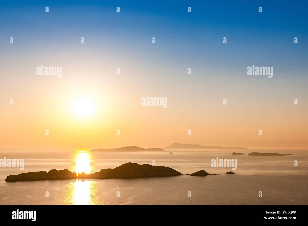 Greece, Ionian Islands, Sun setting over Nisida Kravi island Stock ...
