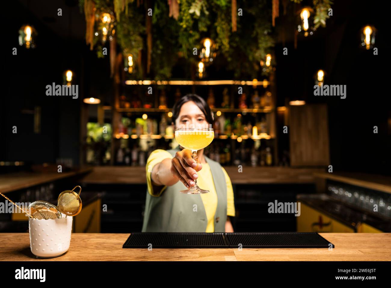 Bartender giving cocktail glass at bar Stock Photo - Alamy