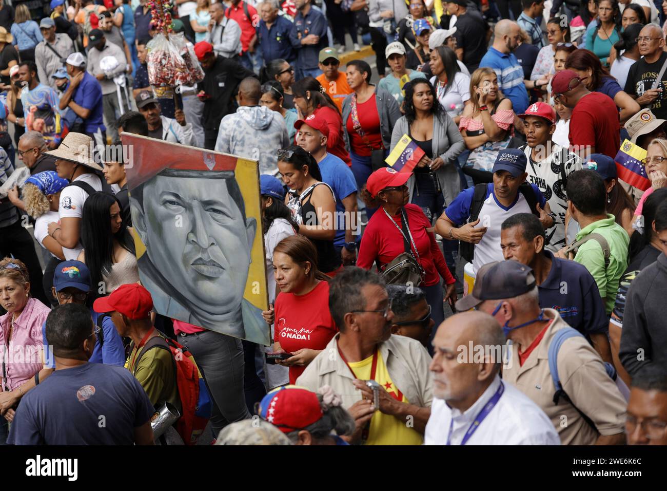 Government supporters hold a painting depicting the late Venezuelan ...