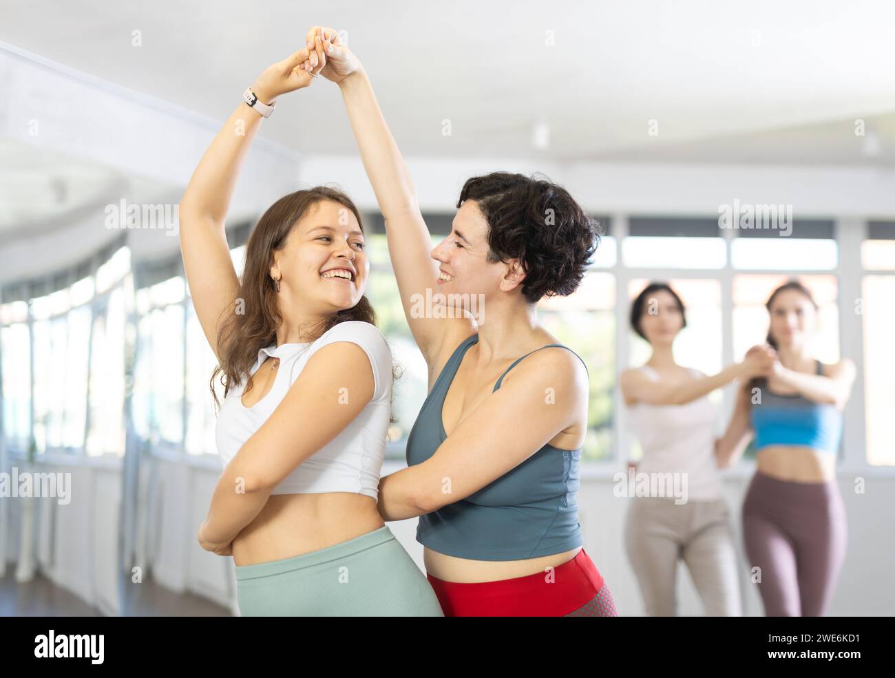 Group of women dancing pair dances in studio Stock Photo - Alamy