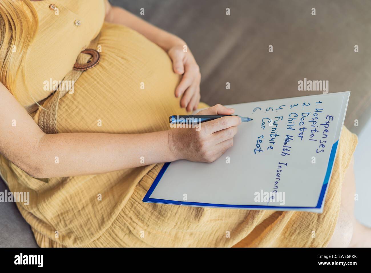 Expectant woman diligently compiles a list of childbirth costs ...