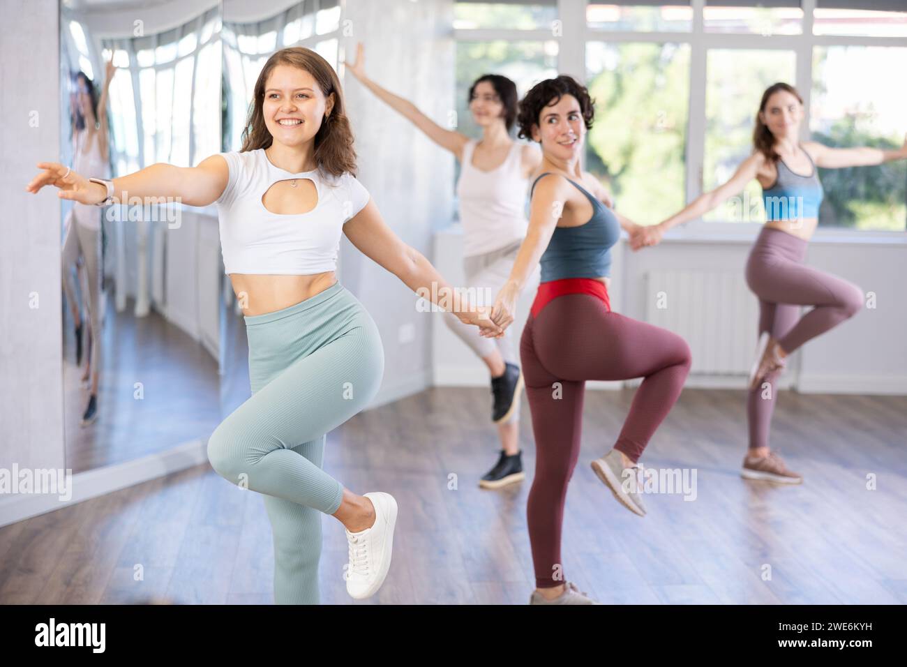 Middle-aged woman and girl are dancing vigorous pair dance in couple ...