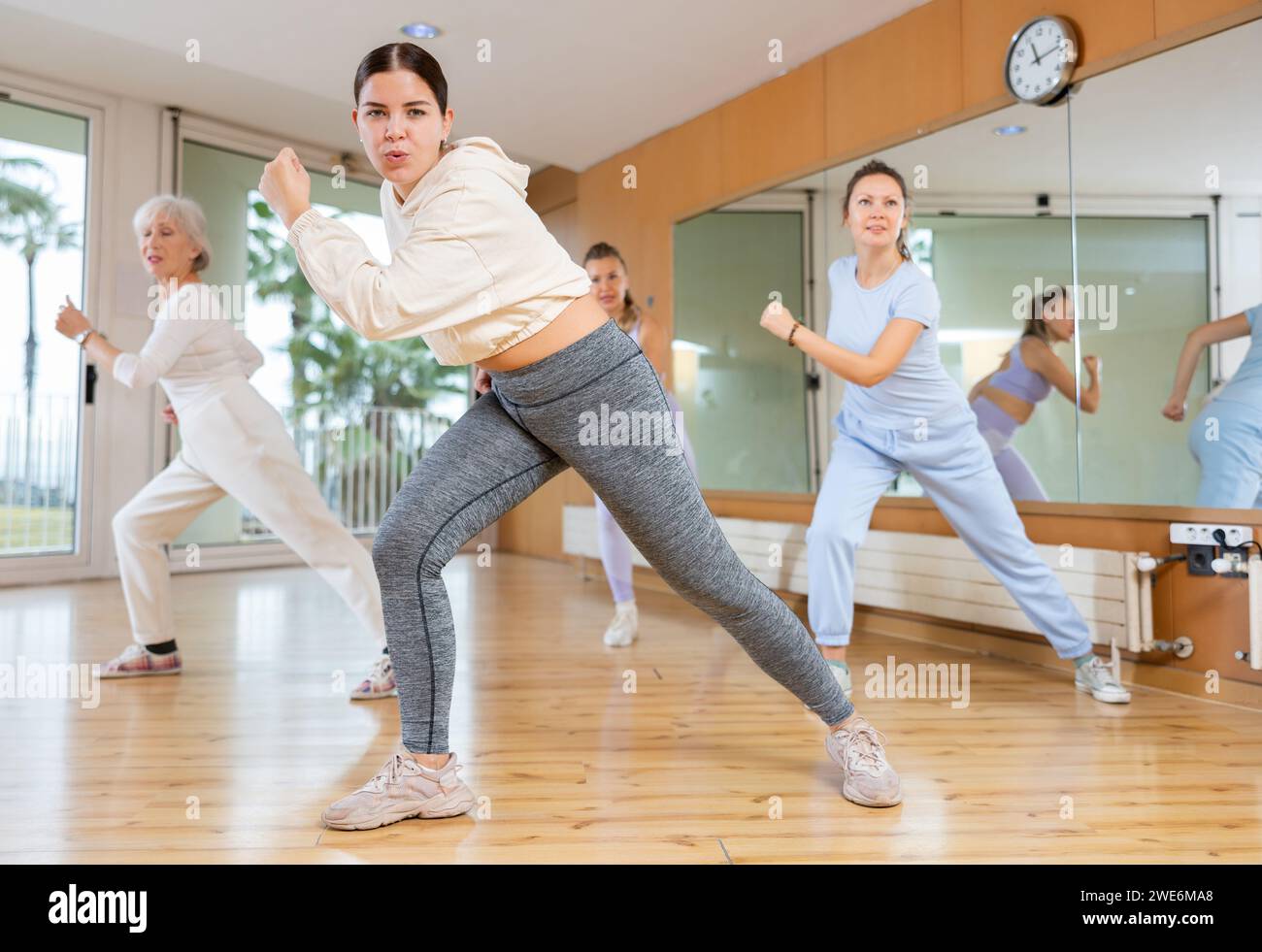 Group of different ages women enjoying active dance movement in studio ...