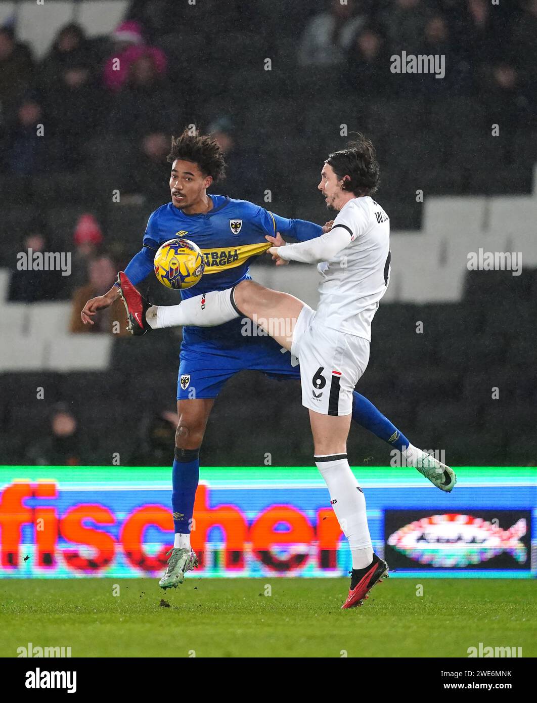 AFC Wimbledon's Aron Sasu and Milton Keynes Dons' Michael Williams ...