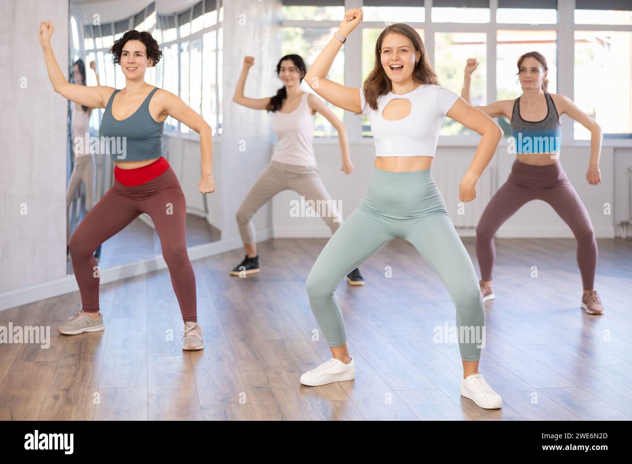 Young female teacher conducts modern hip hop dance lessons for group of ...