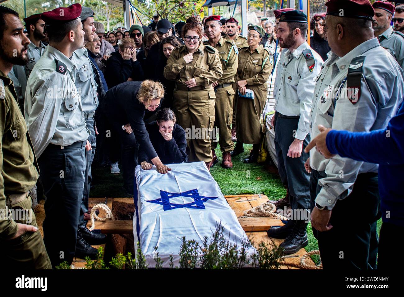 Family members weep as they touch the coffin of Major Ilay Levy during ...