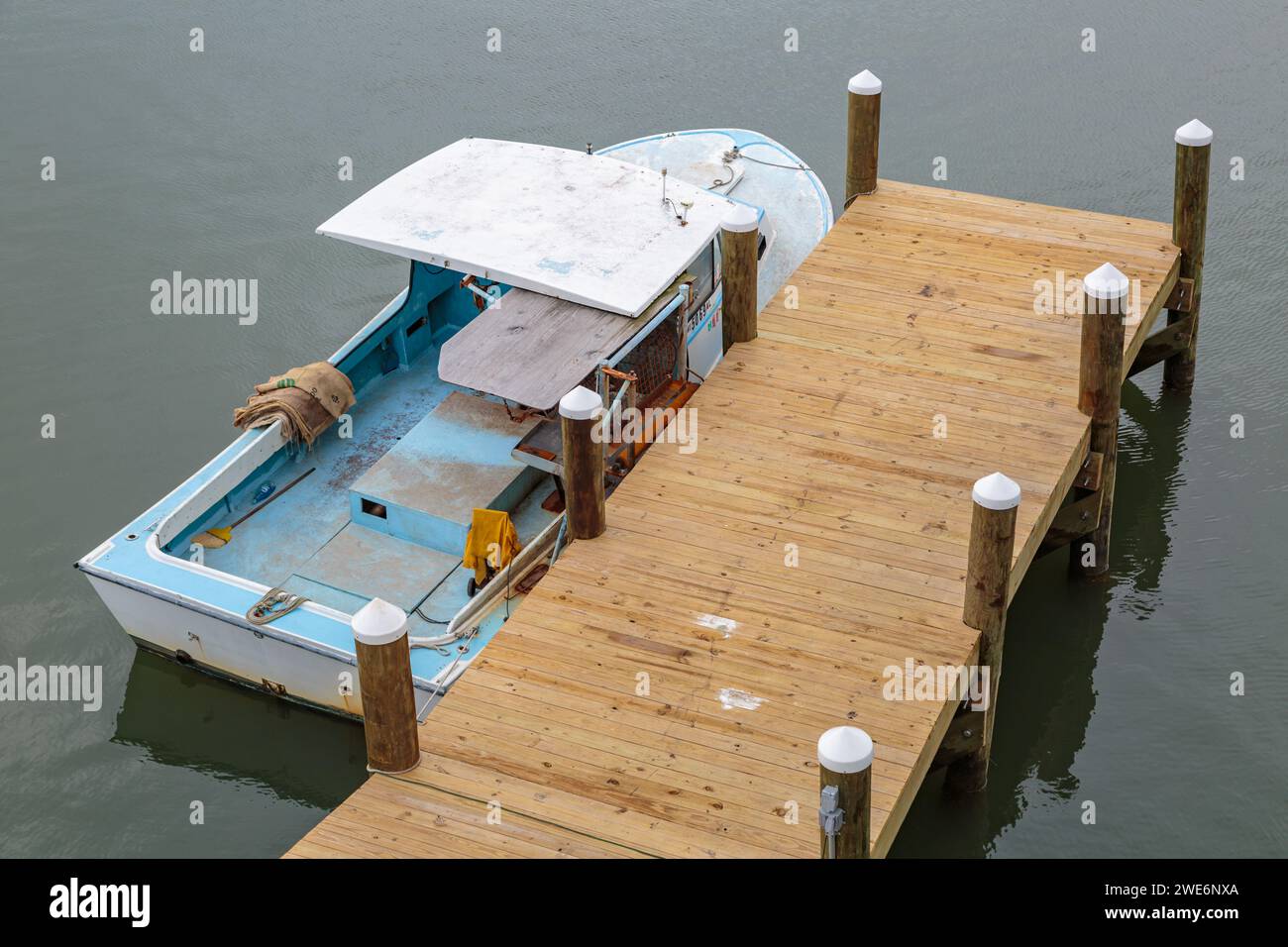 Small commercial fishing boat docked at a wooden pier in Pass Christian ...