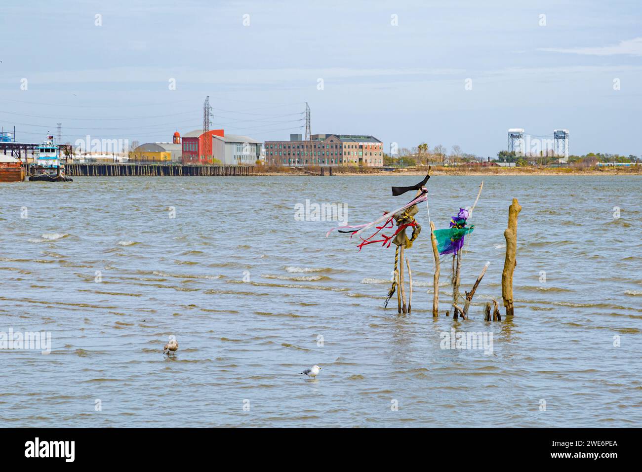 Voodoo dolls on sticks along the shoreline of the Mississippi River at ...
