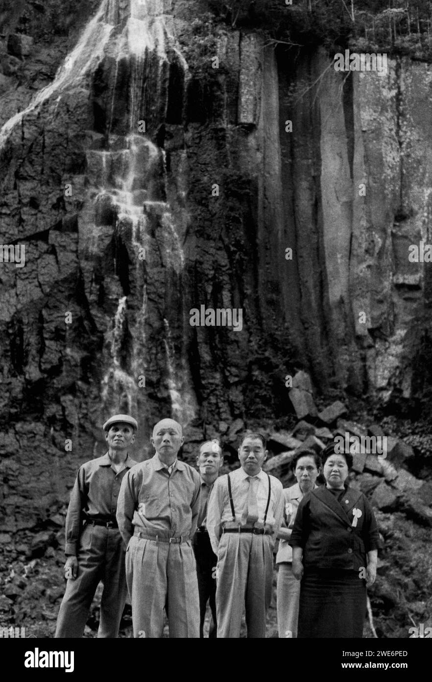 A group of Japanese people in front of a small waterfall Stock Photo ...