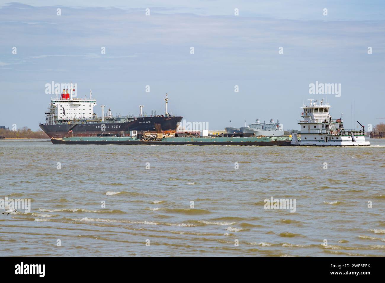 Joseph F Morrison tug boat pushing barges past the Gotland Sofia Oil ...
