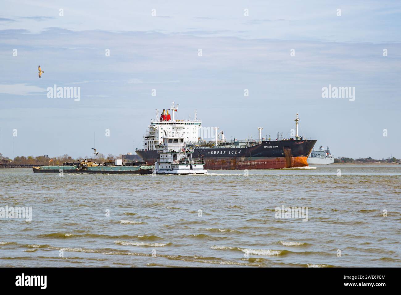 Joseph F Morrison tug boat pushing barges past the Gotland Sofia Oil ...