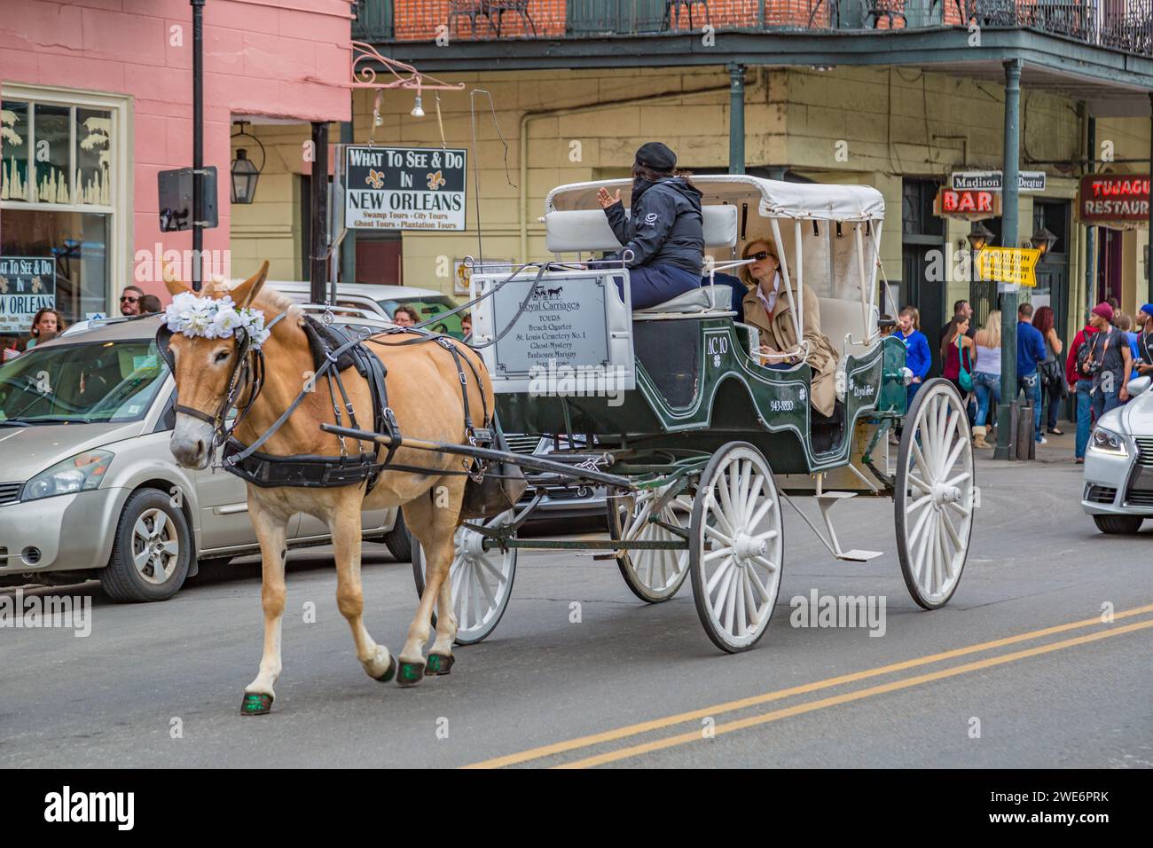 Horse and carriage tour guide talking to tourists as they ride down ...