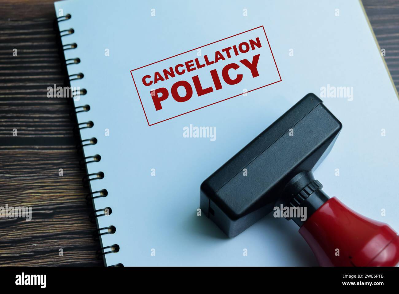 Red Handle Rubber Stamper and Cancellation Policy text above book ...