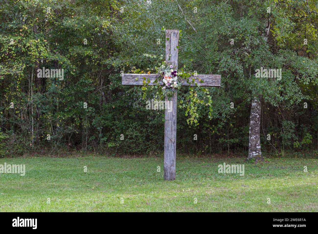 Large wooden cross adorned with flowers at a wedding venue in Central ...